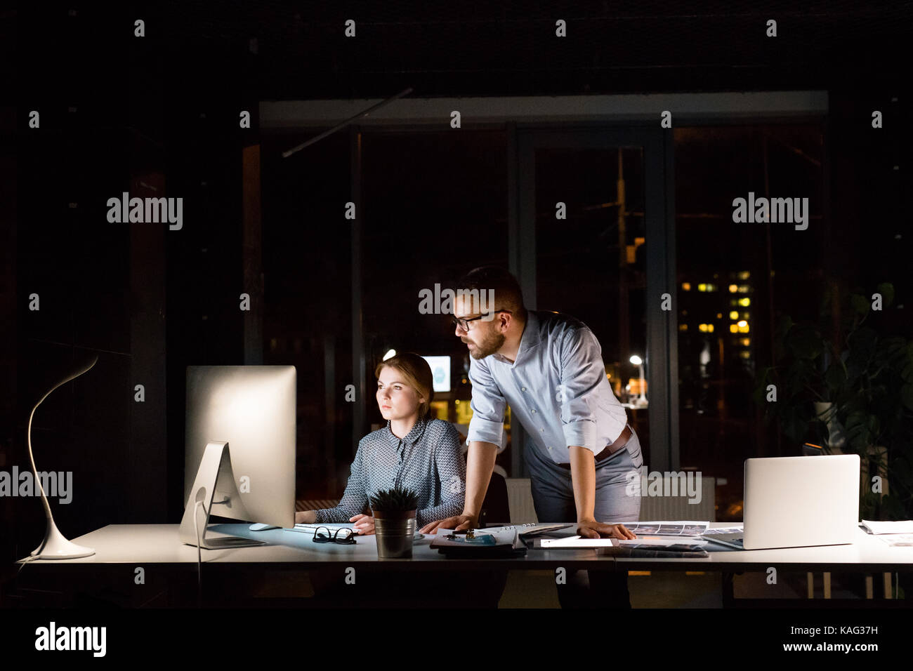 Businesspeople in the office at night working late Stock Photo - Alamy