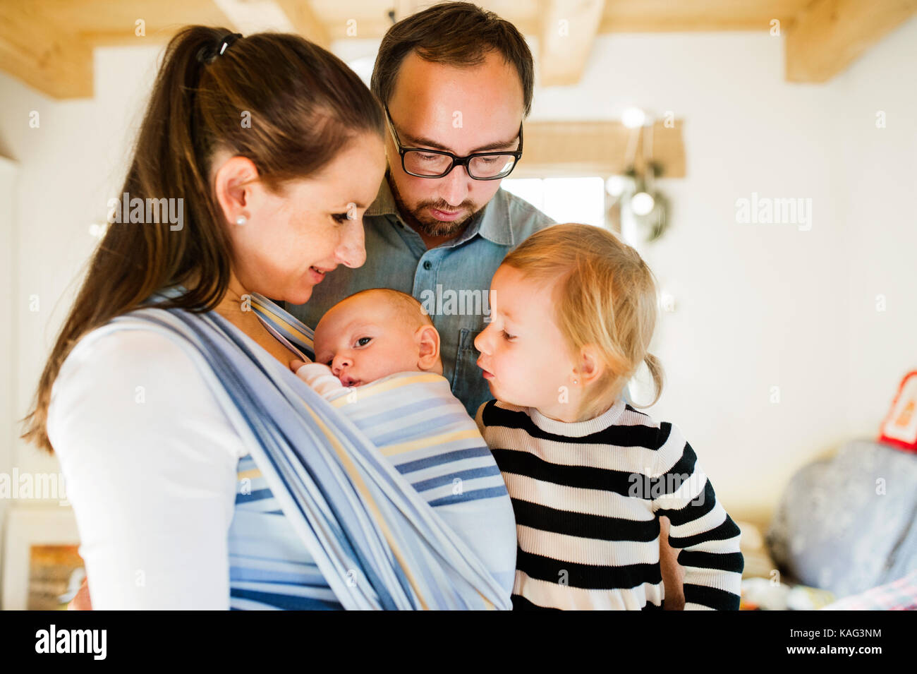 Young parents with two children at Christmas time Stock Photo - Alamy