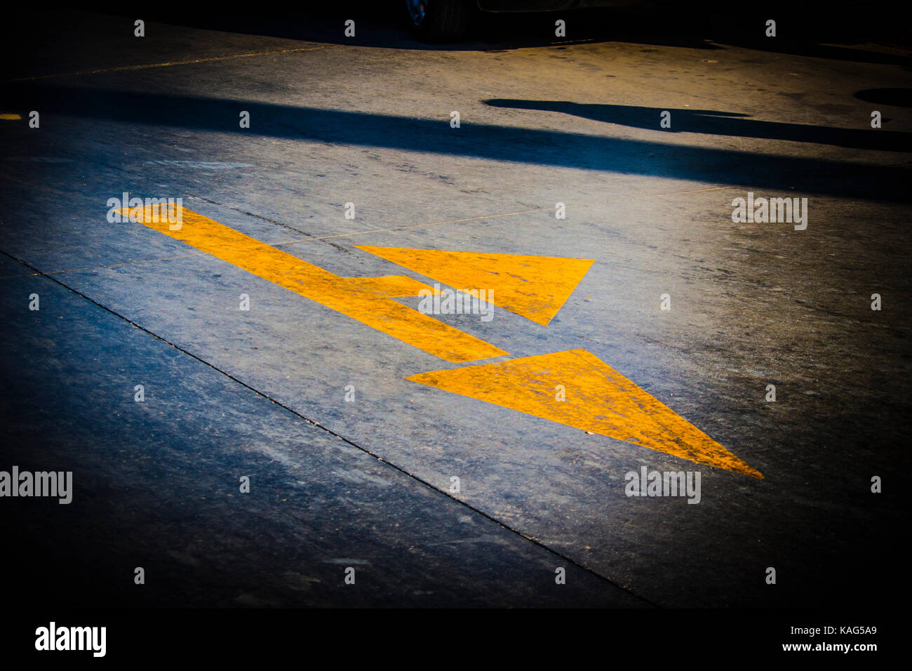 Yellow arrows showing directions on the street Stock Photo - Alamy