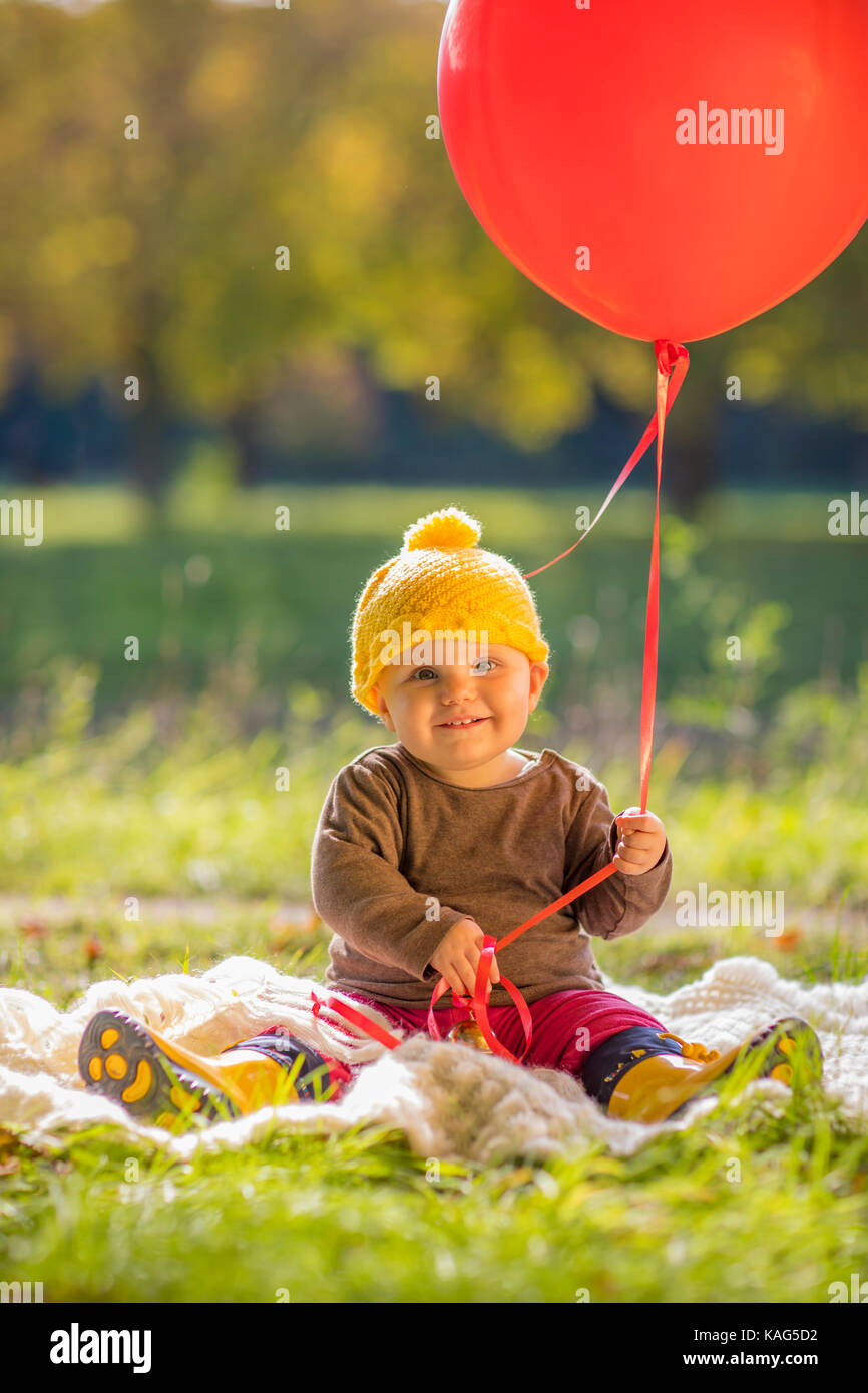 cute happy child baby playing outside in autumn fall sun Stock Photo ...