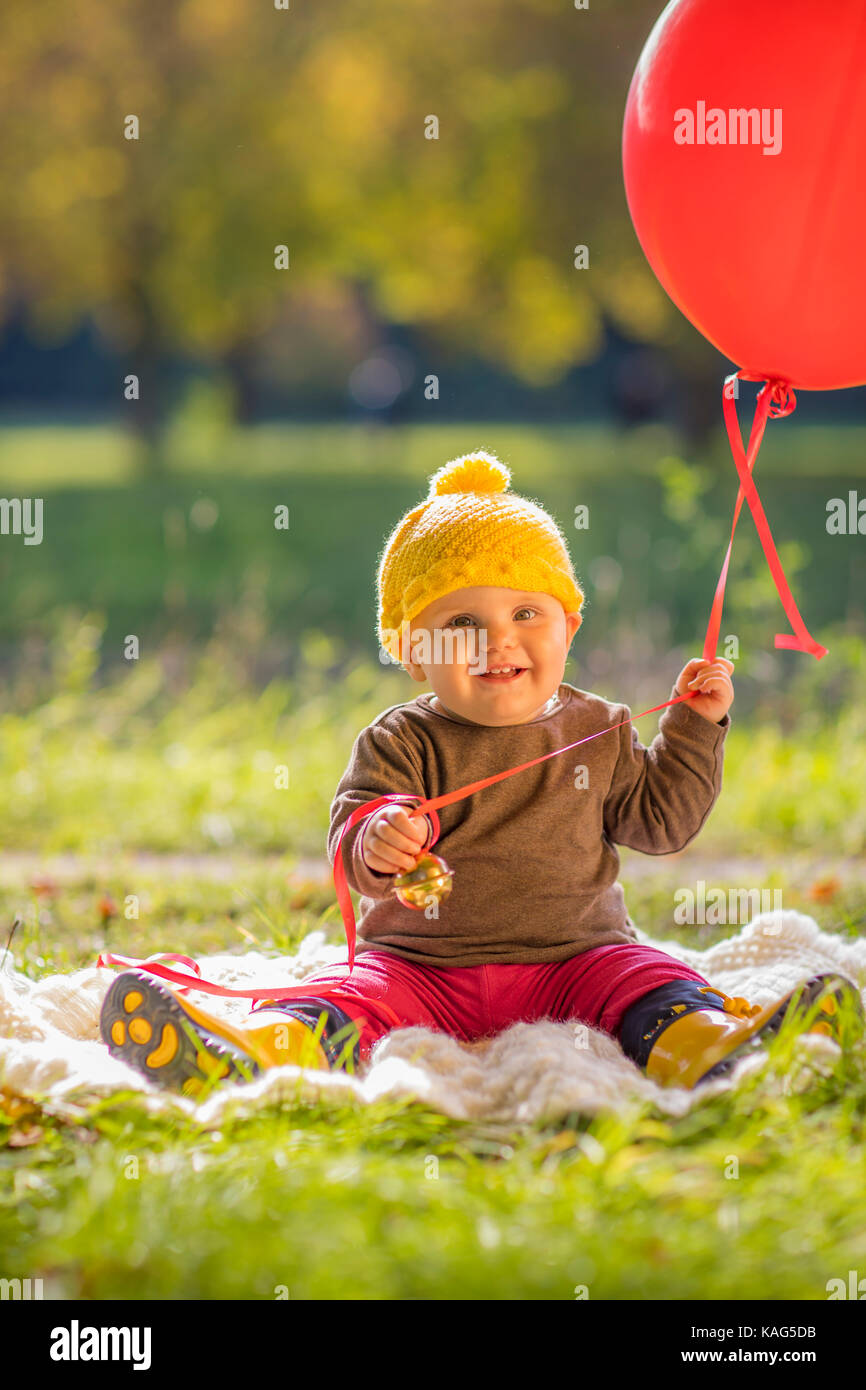 cute happy child baby playing outside in autumn fall sun Stock Photo ...