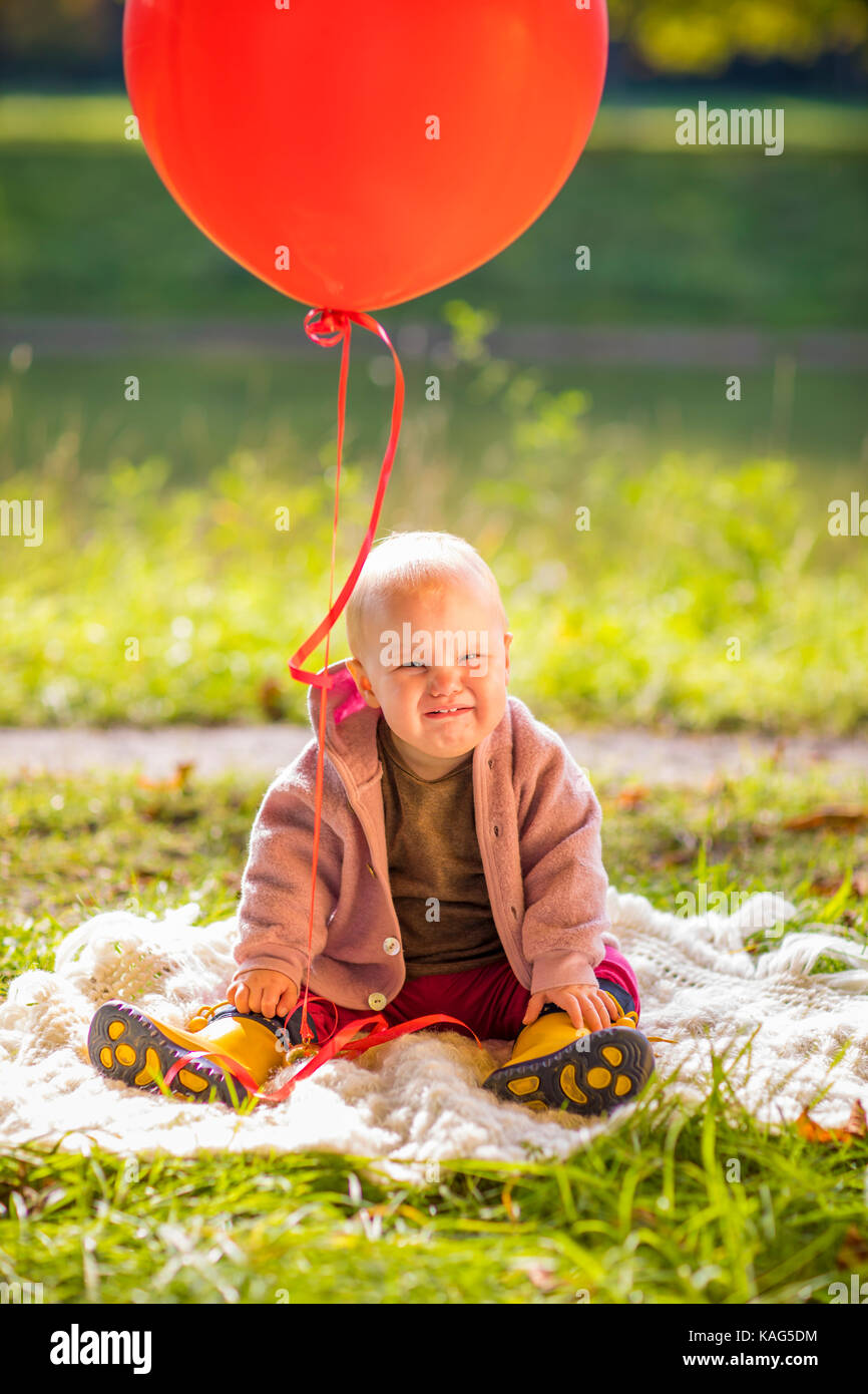 cute happy child baby playing outside in autumn fall sun Stock Photo ...