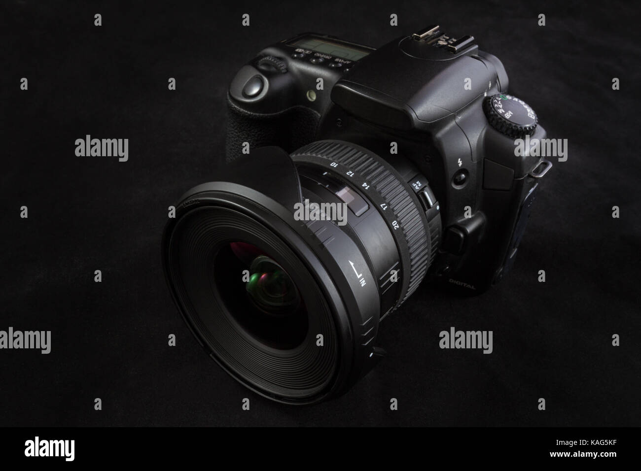 One black camera with wide angle lens isolated on black background ...