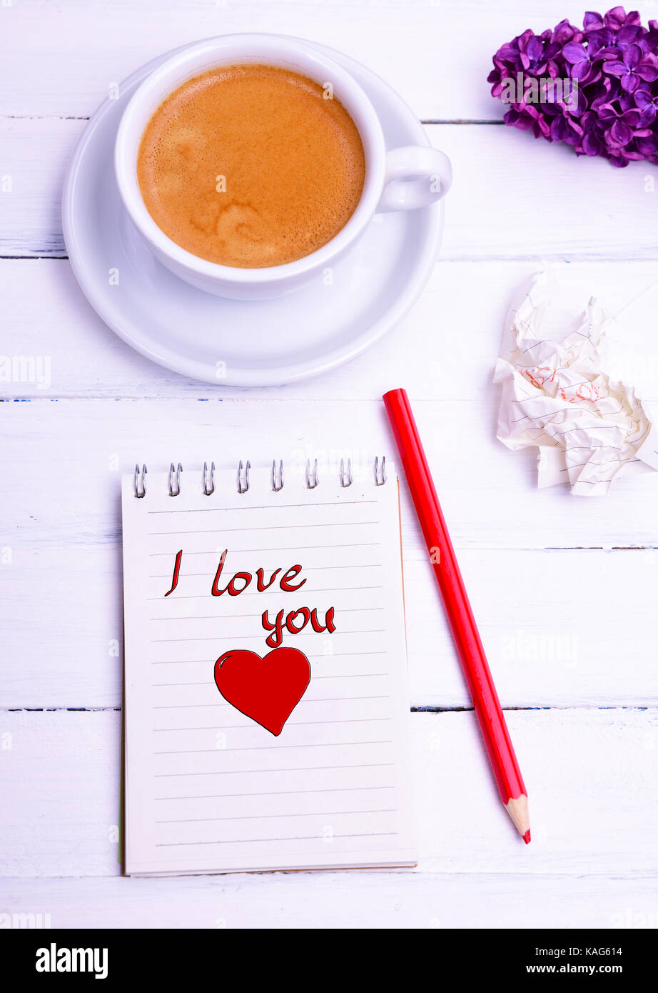 cup of coffee and a paper notebook with the inscription I love you on a ...