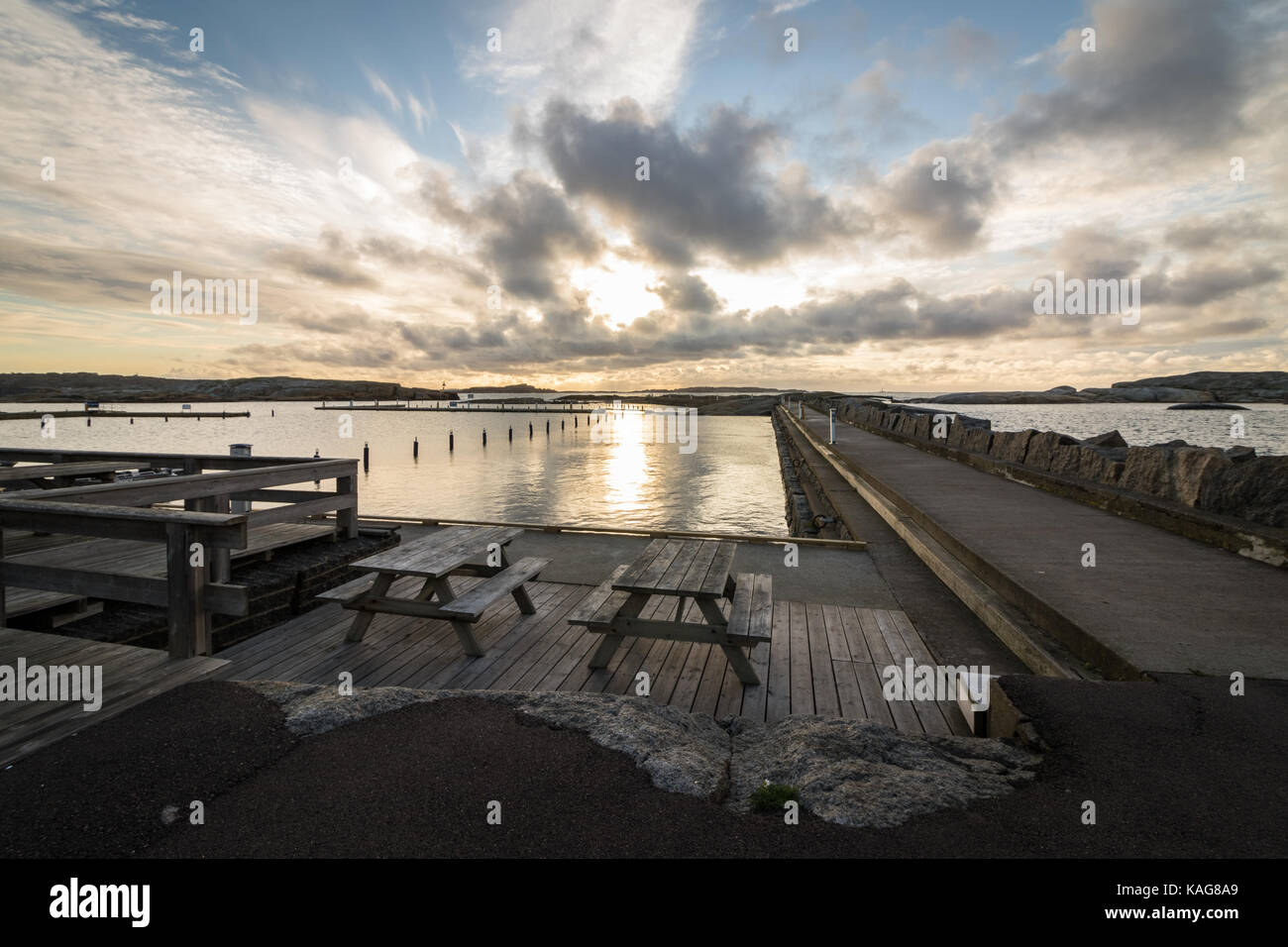 Early morning. Benches in front of the sea, with Faerder National Park ...