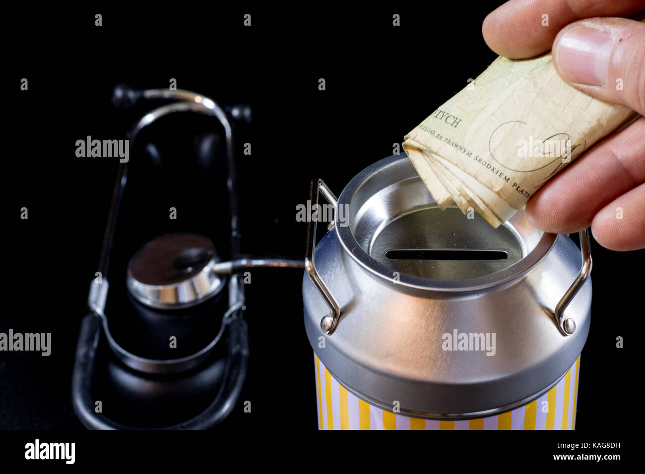 metal piggy bank and coins. Savings and added to a metal piggy bank ...