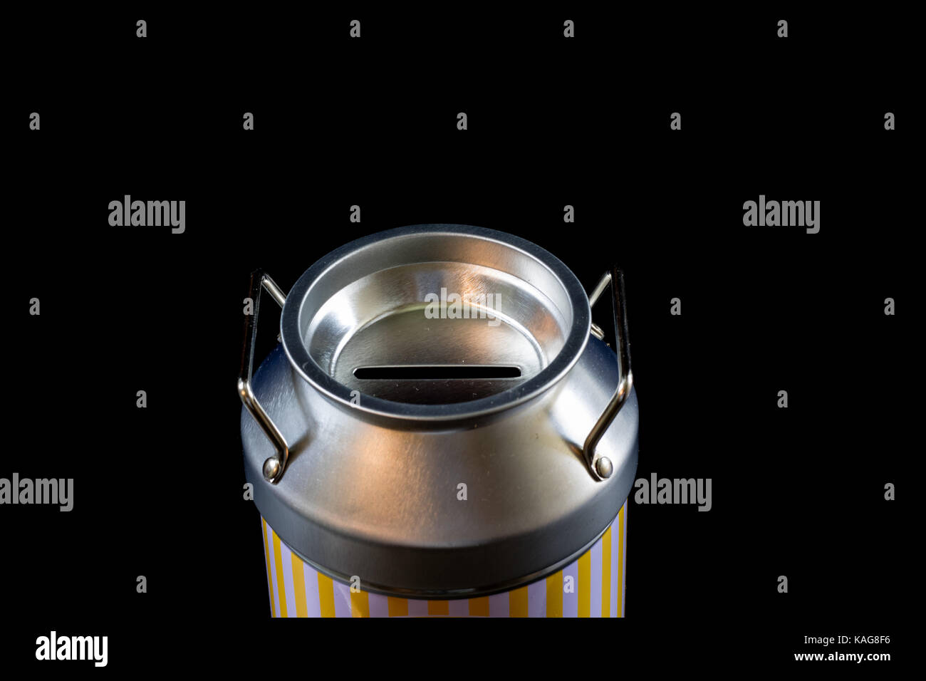 metal piggy bank and coins. Savings and added to a metal piggy bank ...