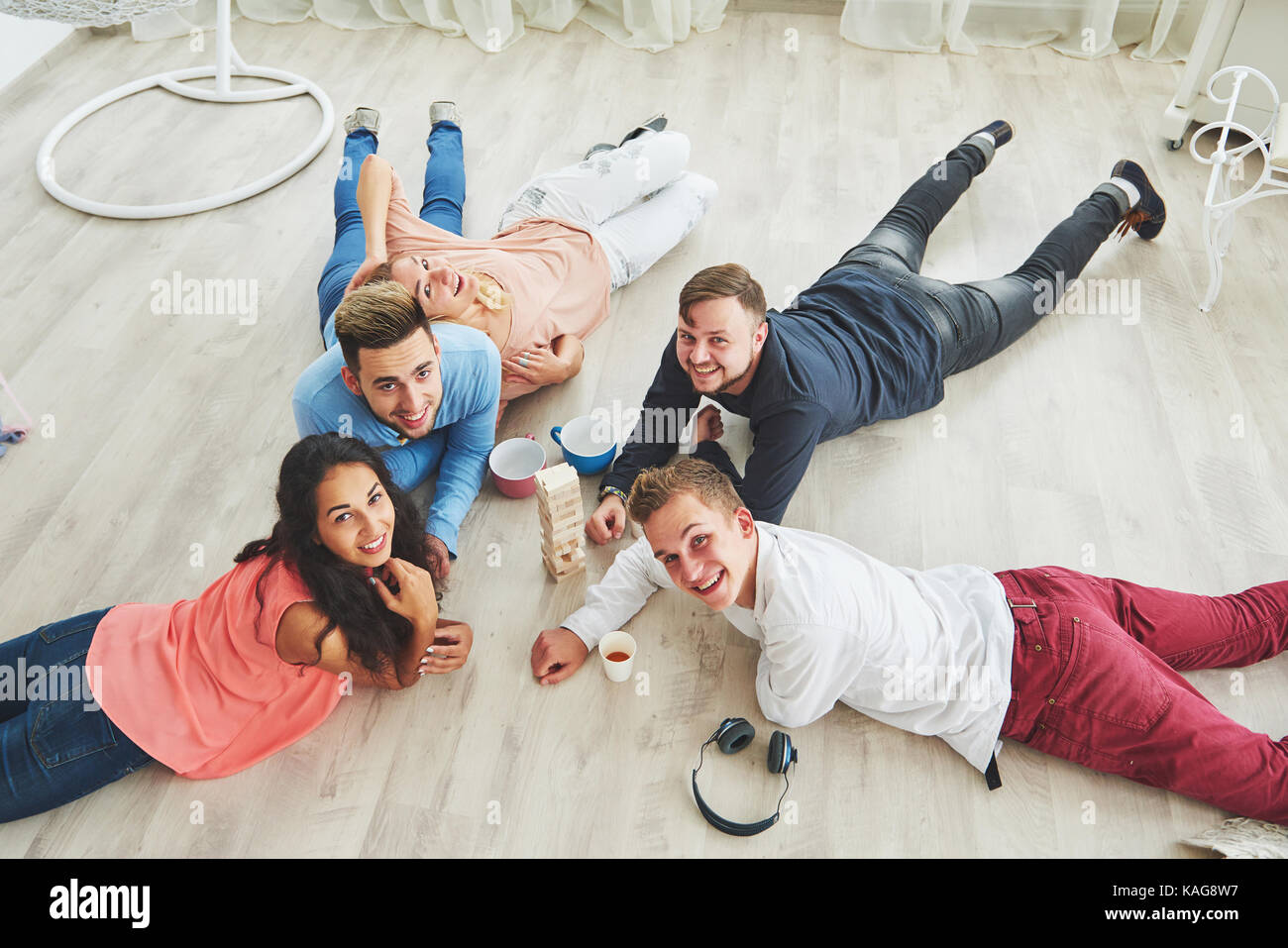 Top view creative photo of friends sitting at wooden table. Friends ...