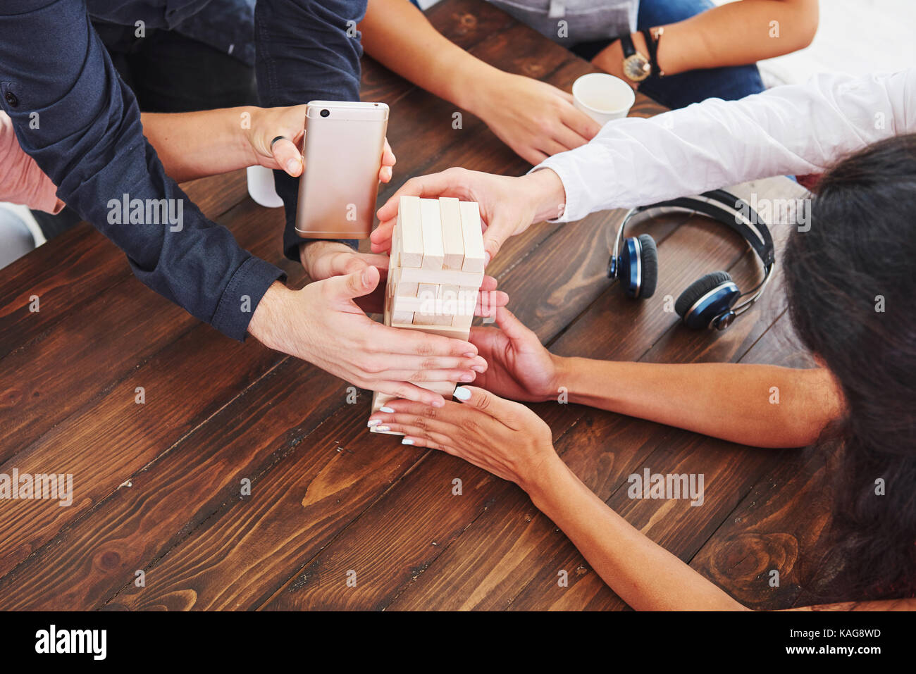 Top view creative photo of friends sitting at wooden table. Friends ...