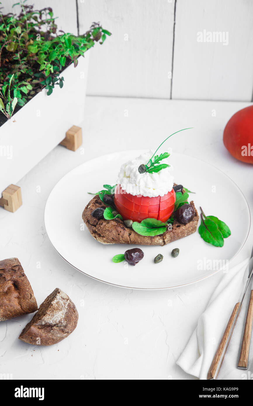 Cretan appetizer dakos. Rusk with feta cheese, tomato, olive oil and ...