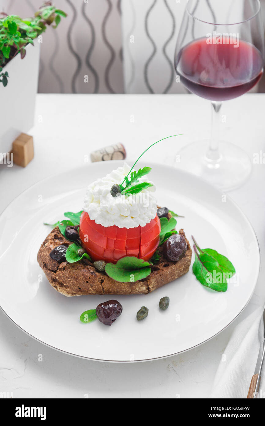 Dakos barley rusk with mizitra cheese, tomato, olives, oregano and ...