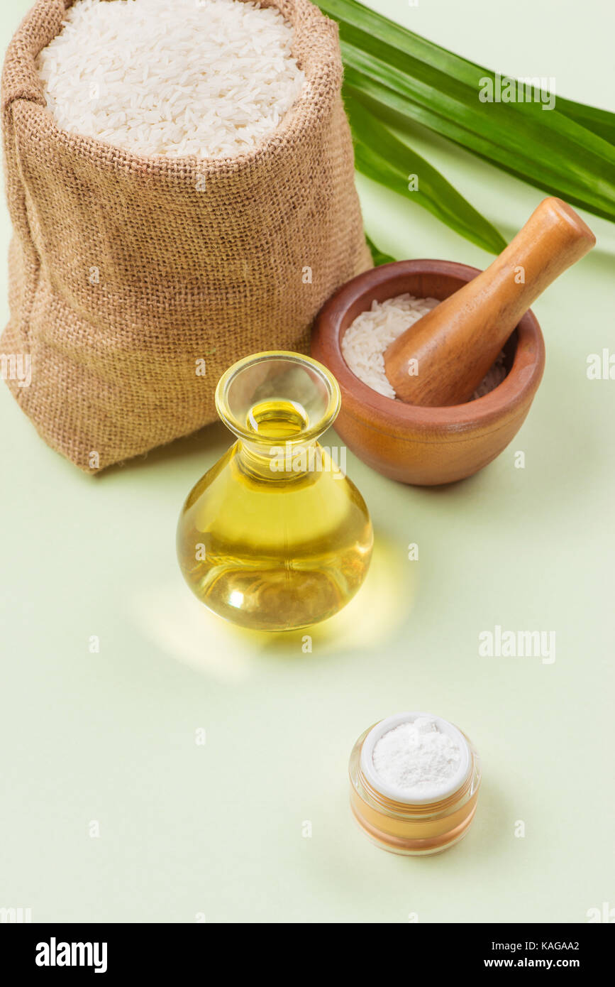 Rice oil in bottle glass and milk over green background Stock Photo - Alamy