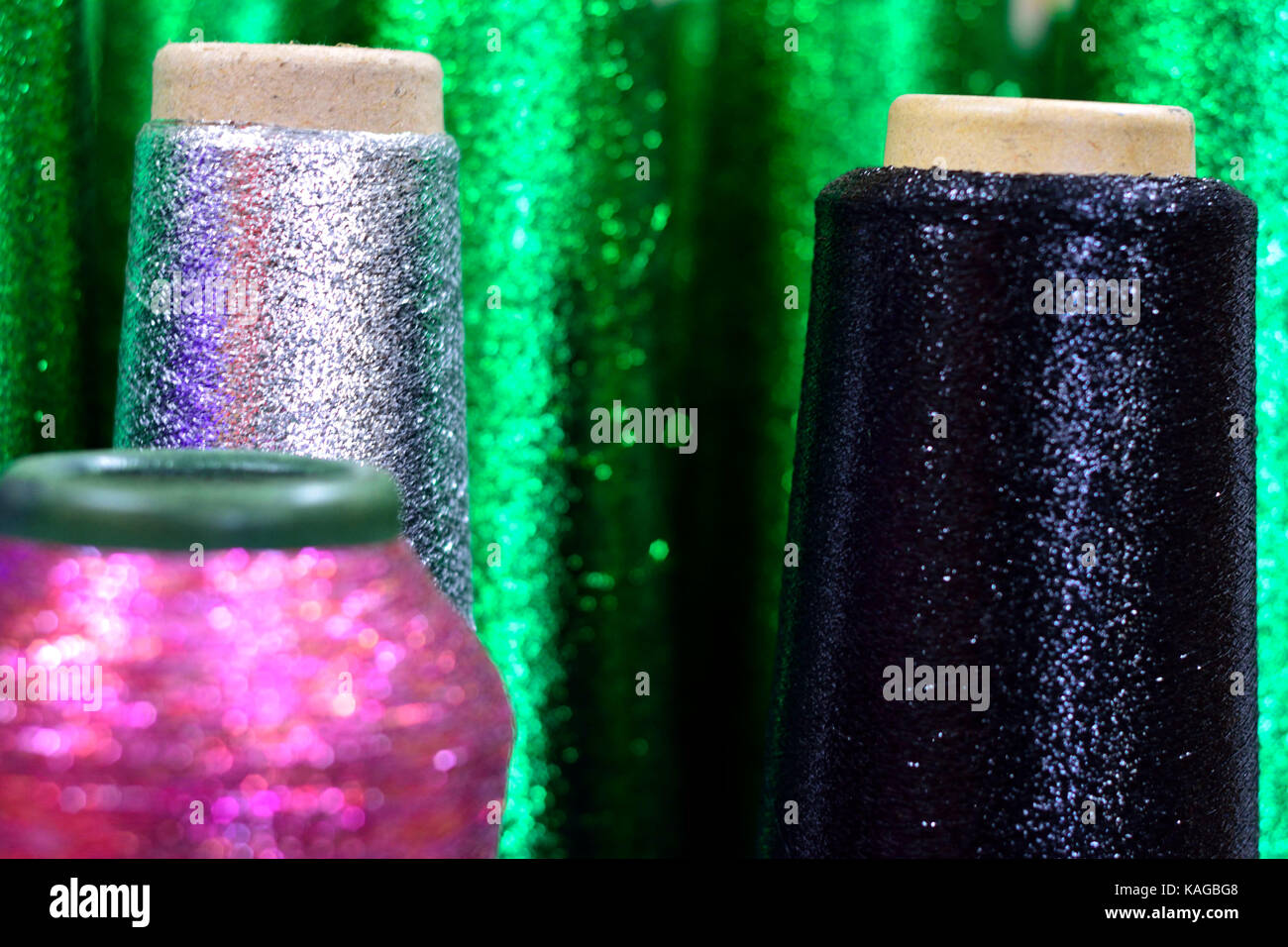 spools of shiny colourful machine sewing thread Stock Photo - Alamy