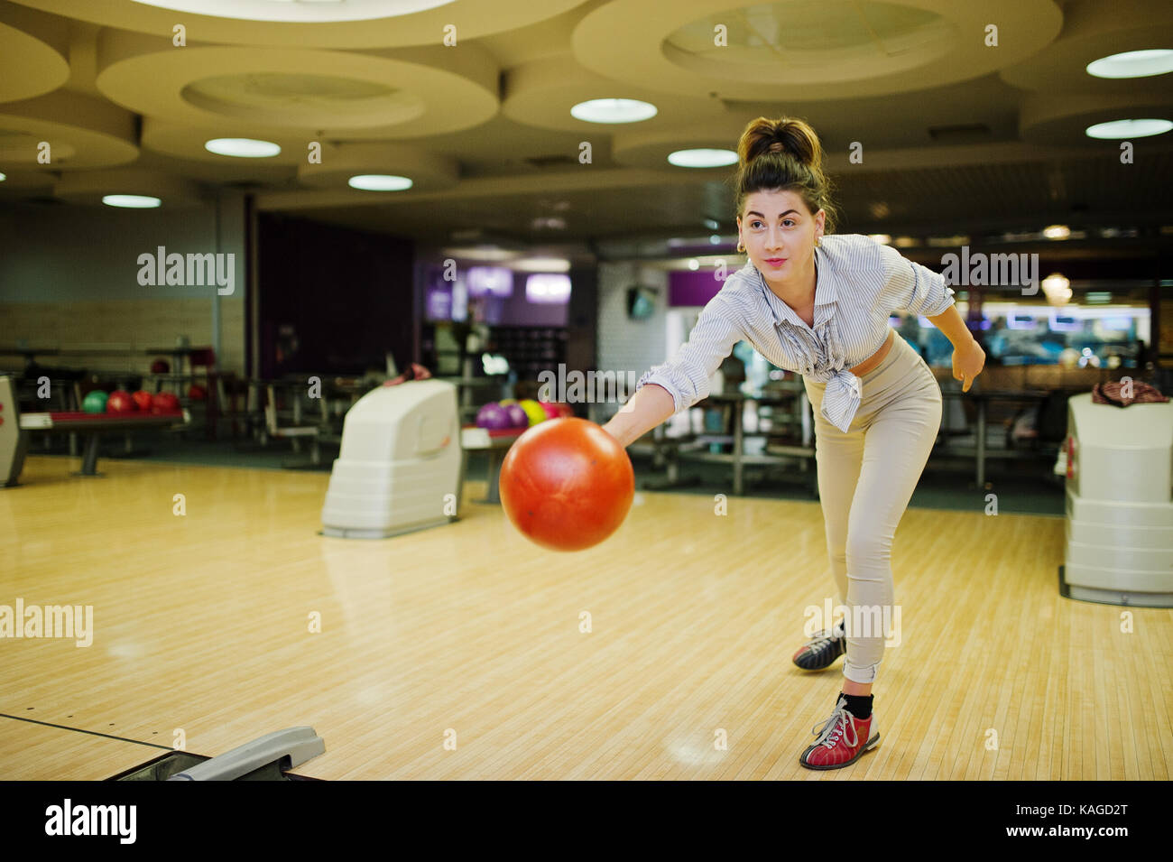 Girl with bowling ball on alley played at bowling club Stock Photo - Alamy