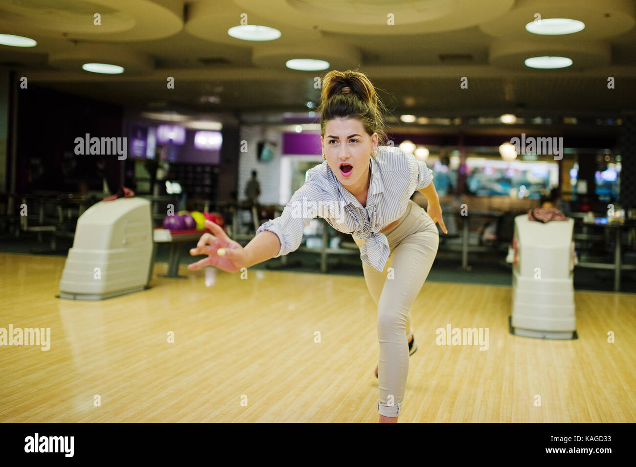 Girl with bowling ball on alley played at bowling club Stock Photo - Alamy