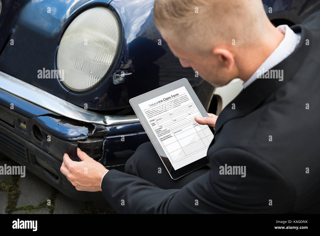 Insurance Agent Inspecting Damaged Car With Insurance Claim Form On ...