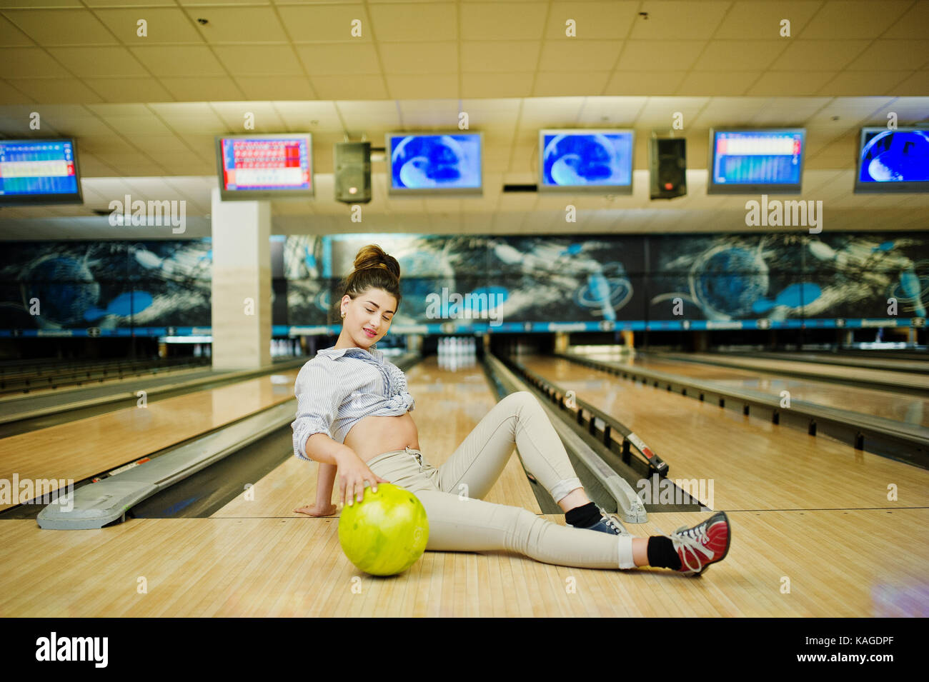 Girl with bowling ball on alley played at bowling club Stock Photo - Alamy