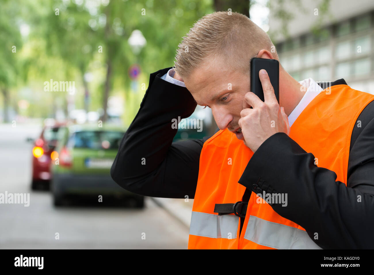 Young Male Driver Making Phone Calls With A Broken Down Cars On Road ...