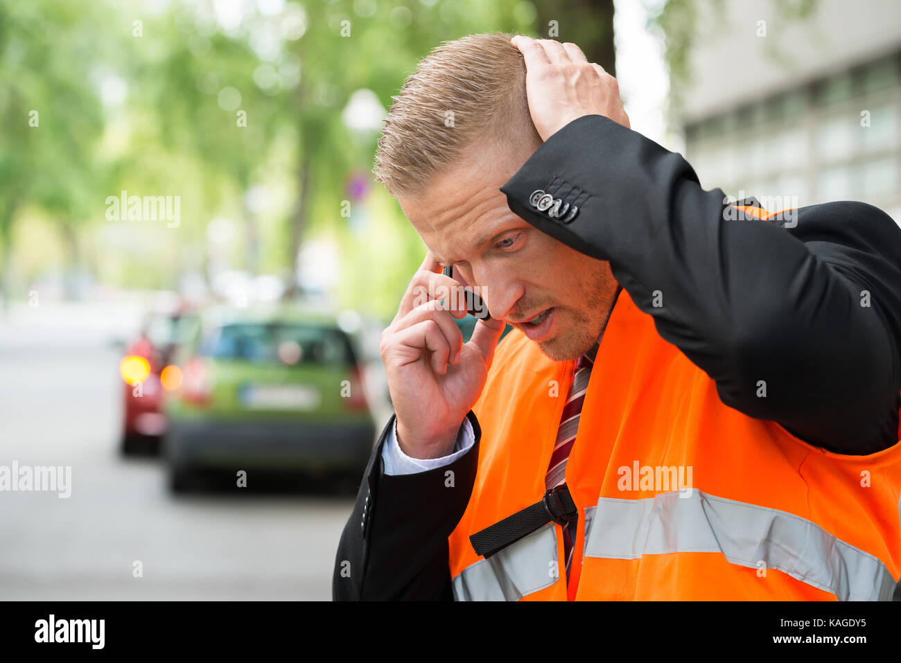 Young Male Driver Making Phone Calls With A Broken Down Cars On Road ...