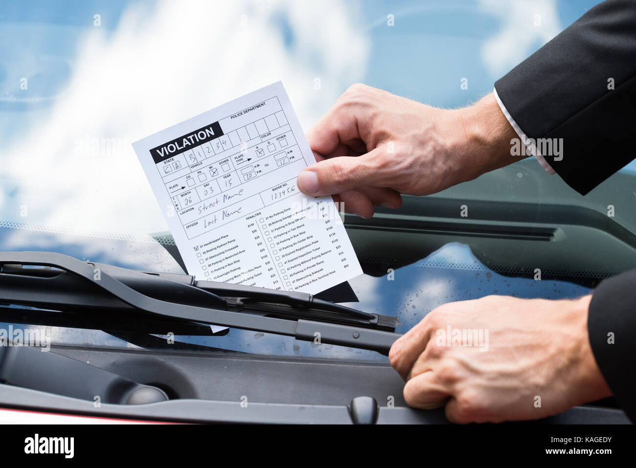 Close-up Of A Man Taking Parking Ticket On Car's Windshield Stock Photo ...