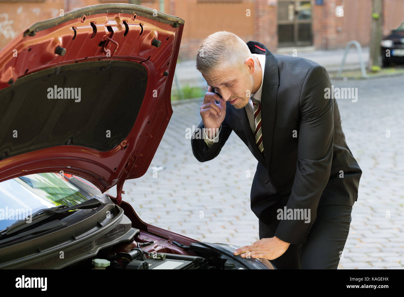 Portrait Of A Young Man Calling On Cellphone For Car Service Stock ...