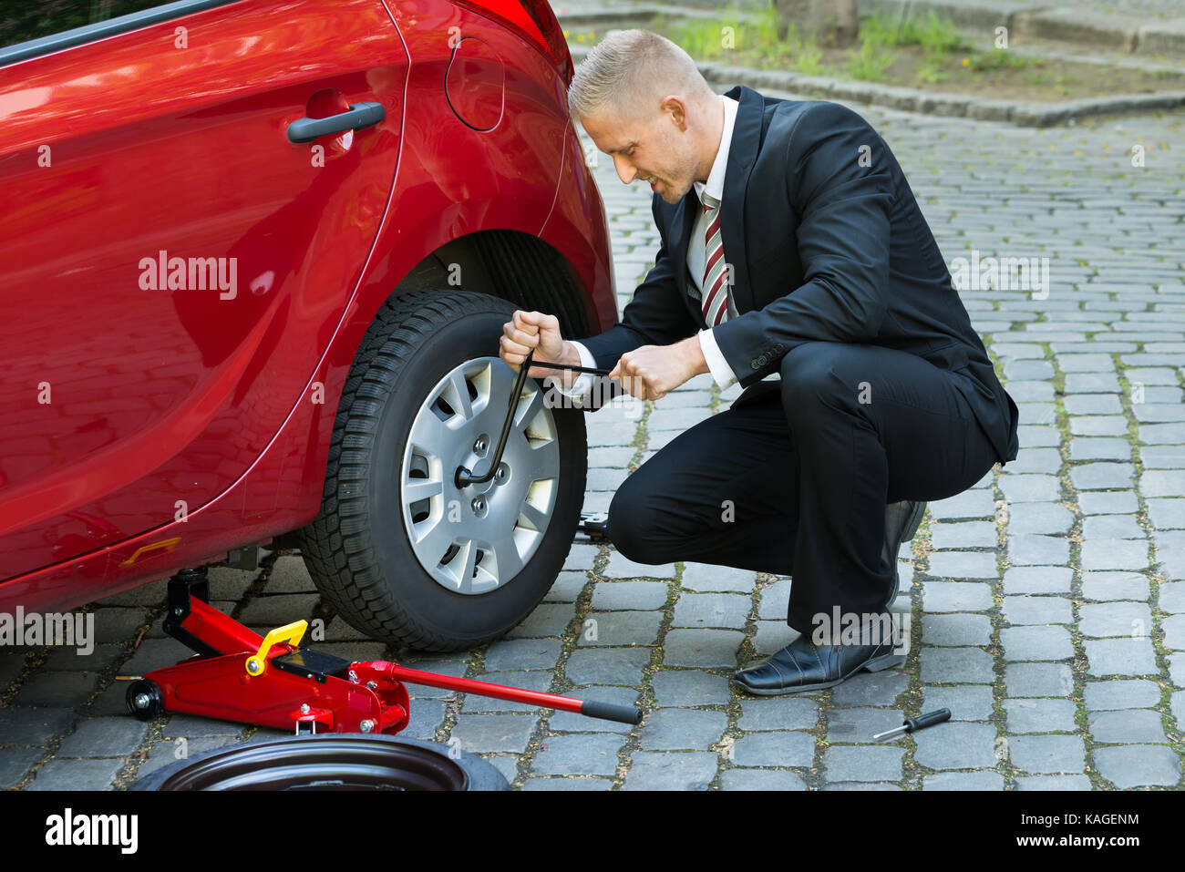 Portrait Of A Male Driver Having Trouble For Changing Wheel Stock Photo ... Portrait Of A Male Driver Having Trouble For Changing Wheel Stock Photo ...