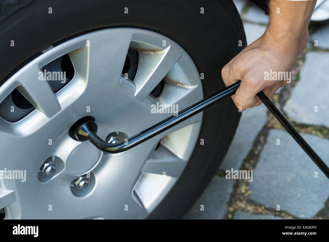 Close-up Of Male Tightening The Nuts With A Wheel Spanner Stock Photo ...