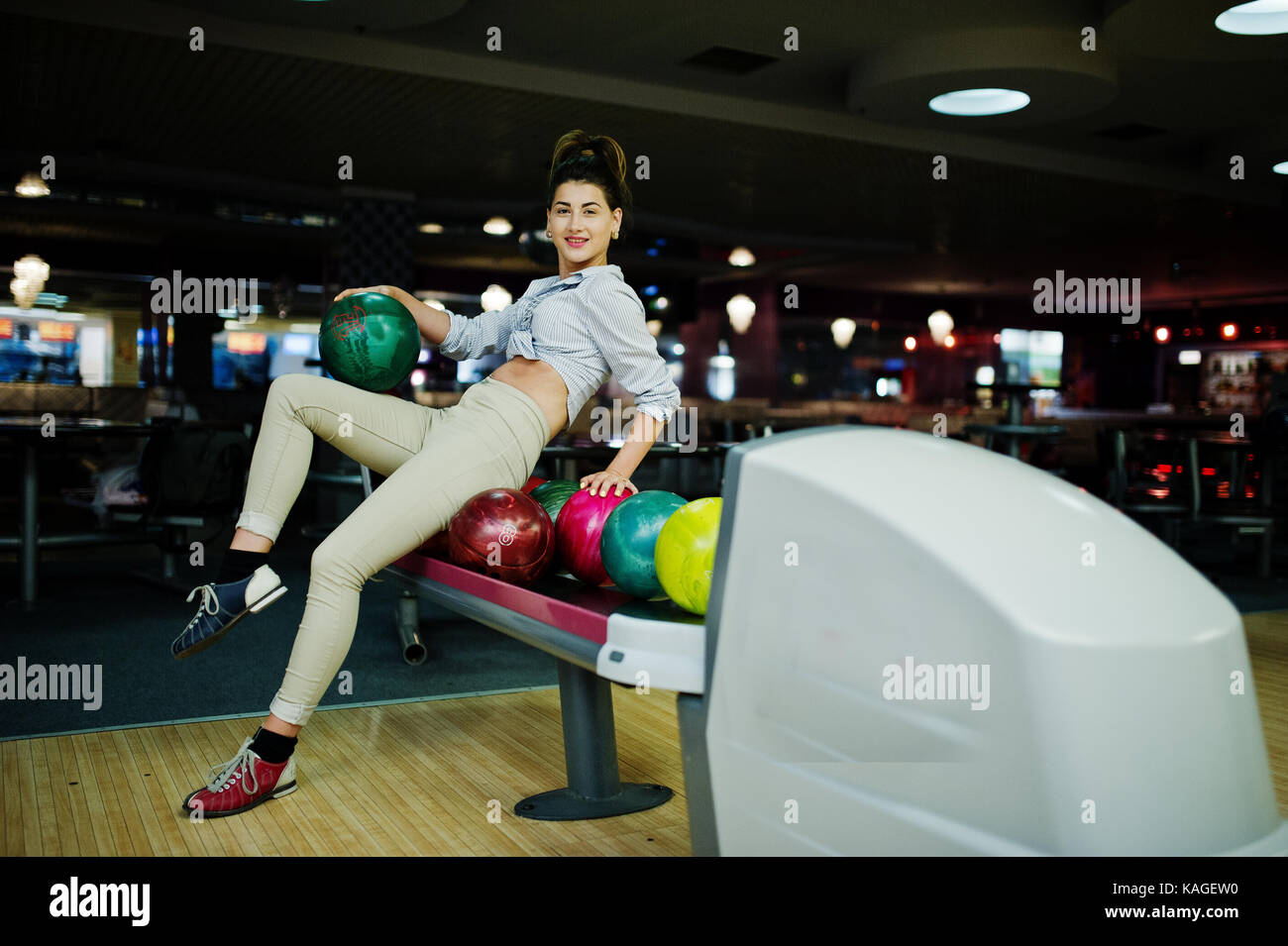 Girl with bowling ball on alley played at bowling club Stock Photo - Alamy