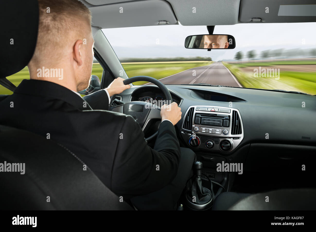 Rear View Of A Young Businessman Driving Car Stock Photo - Alamy