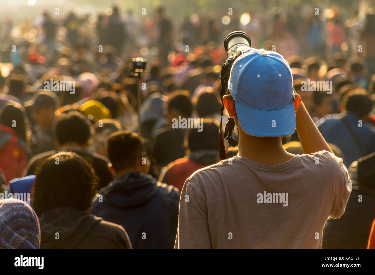 Person photographer back with many blur people Stock Photo - Alamy