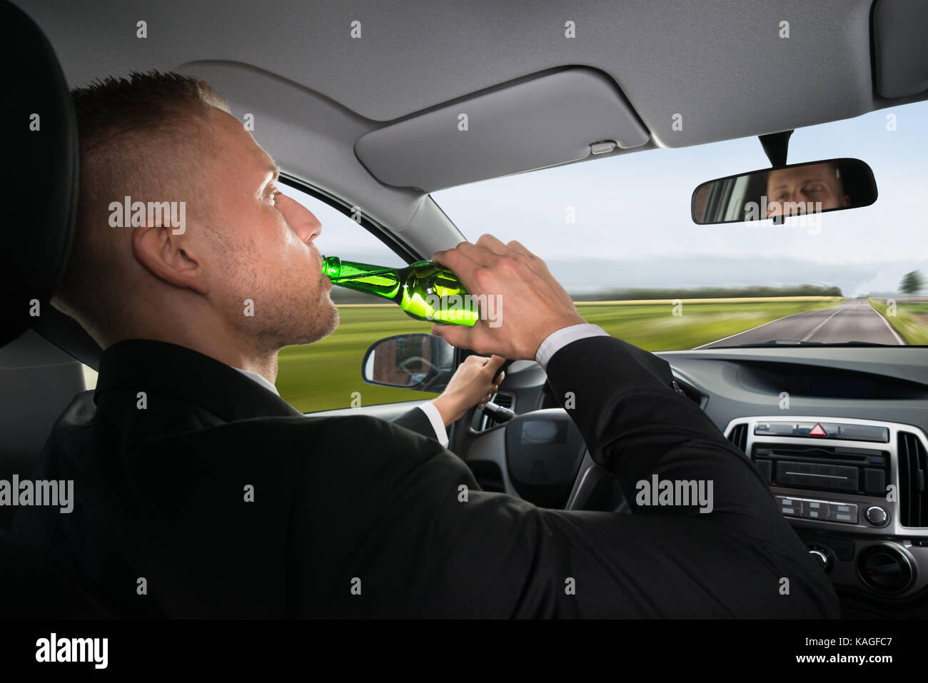 Close-up Of A Businessman Drinking Beer While Driving Car Stock Photo ...