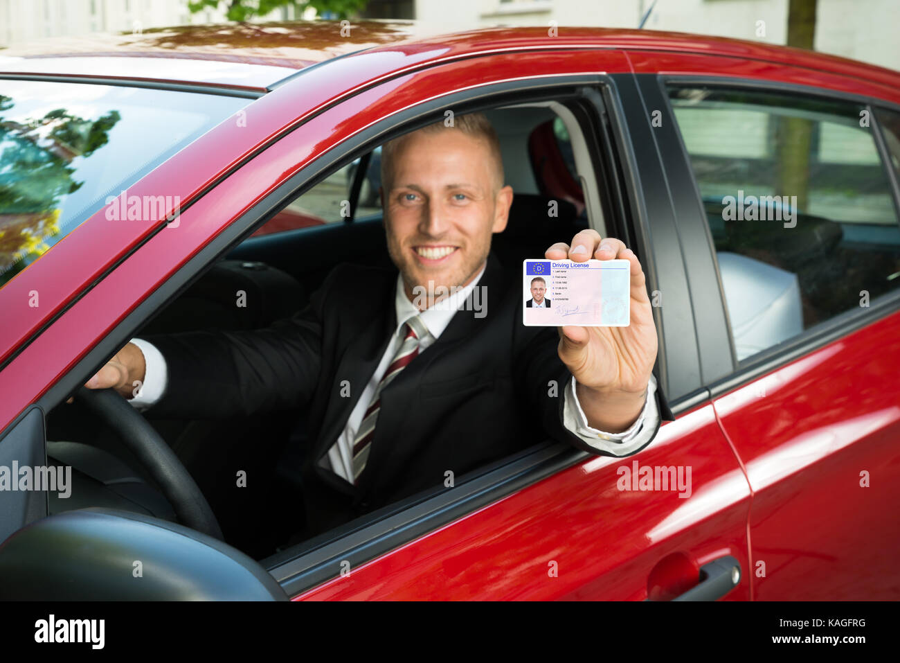 Portrait Of A Young Businessman Showing His Driving License From Open ...