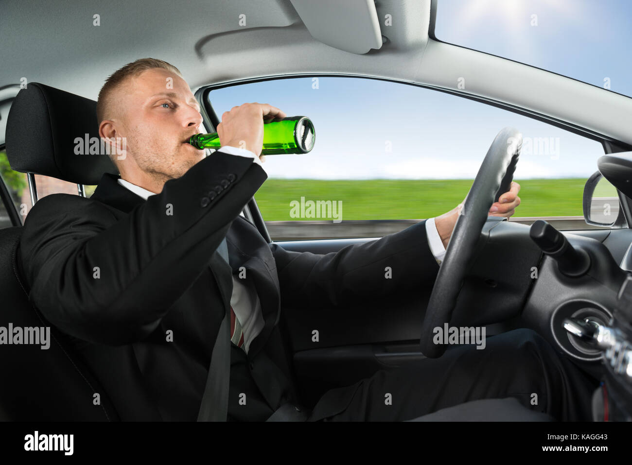 Hand holding beer bottle driving hi-res stock photography and images ...