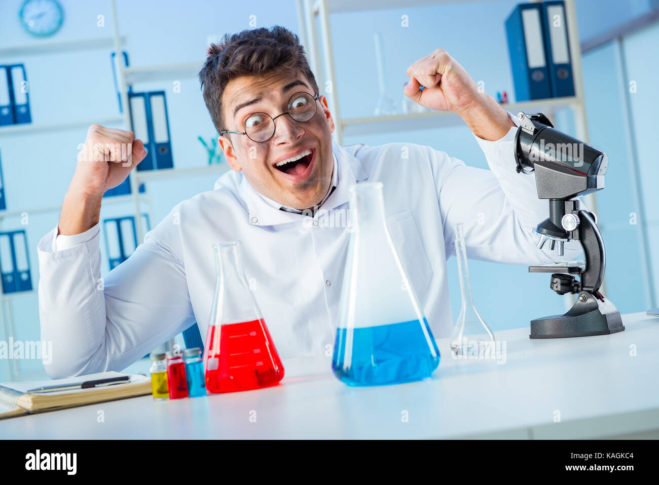 Funny mad chemist working in a laboratory Stock Photo - Alamy
