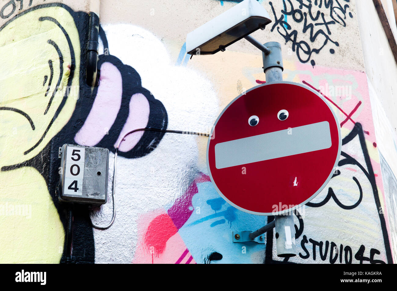 Defaced road sign with googly eyes Stock Photo - Alamy