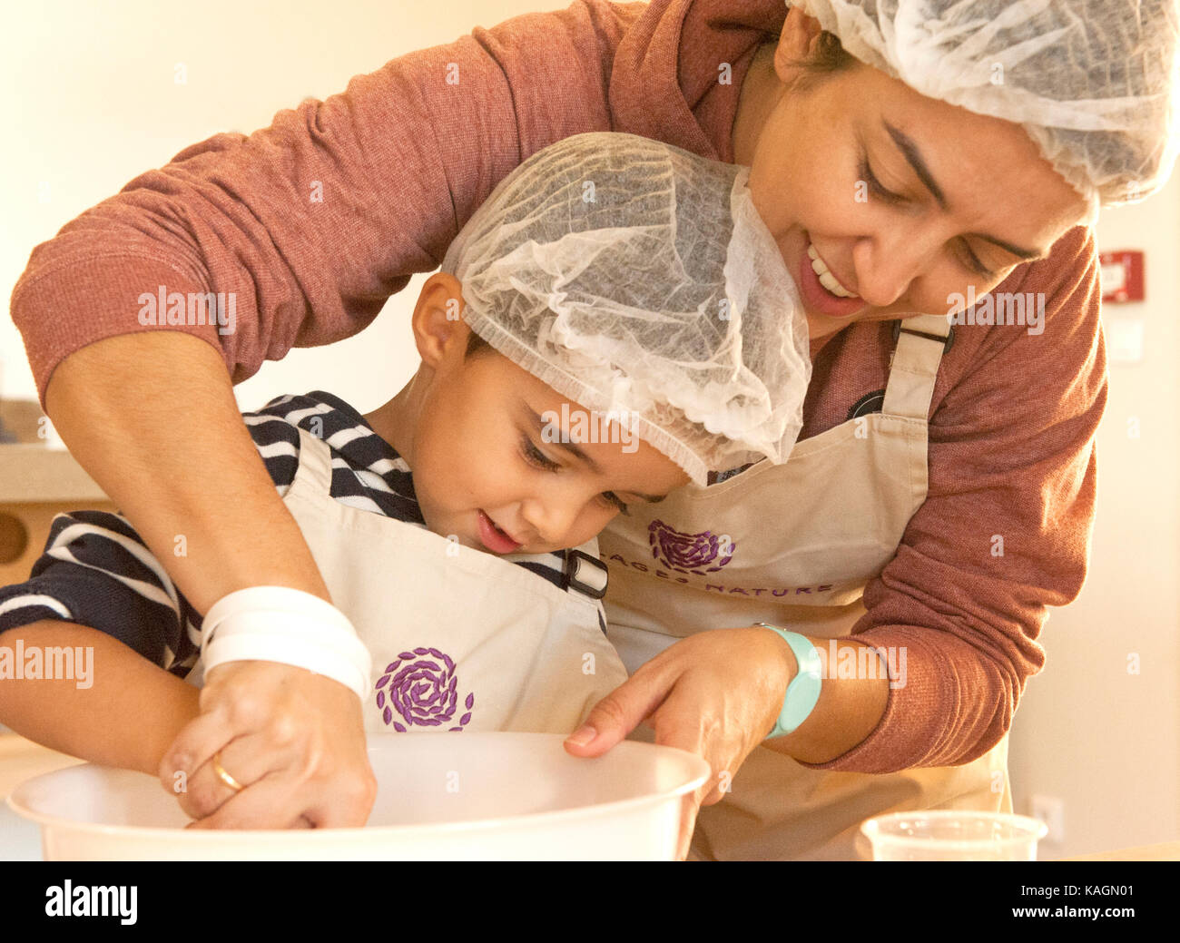 A mother baking bread with her young boy at Villages Nature Paris Stock ...