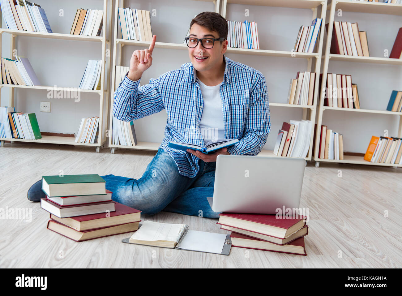 Young student studying with books Stock Photo - Alamy