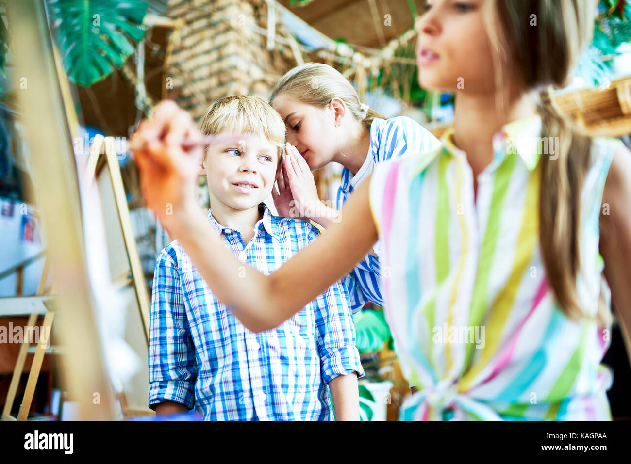 Gossiping Children in Art Class Stock Photo - Alamy