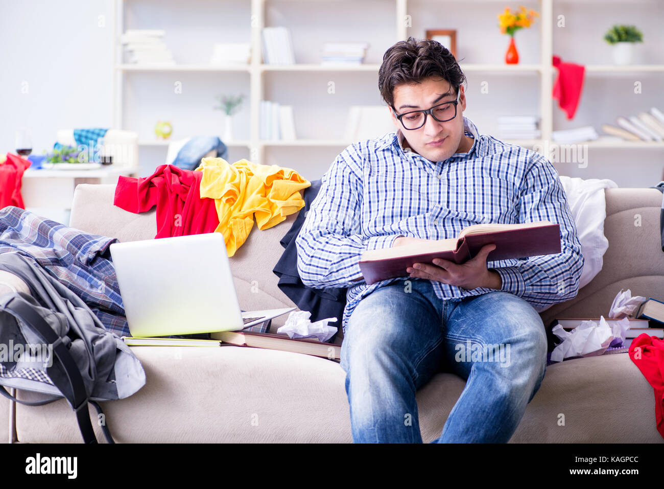 Young man working studying in messy room Stock Photo - Alamy