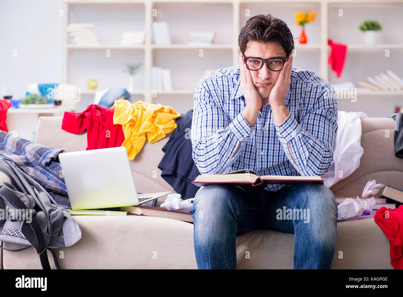 Young man working studying in messy room Stock Photo - Alamy