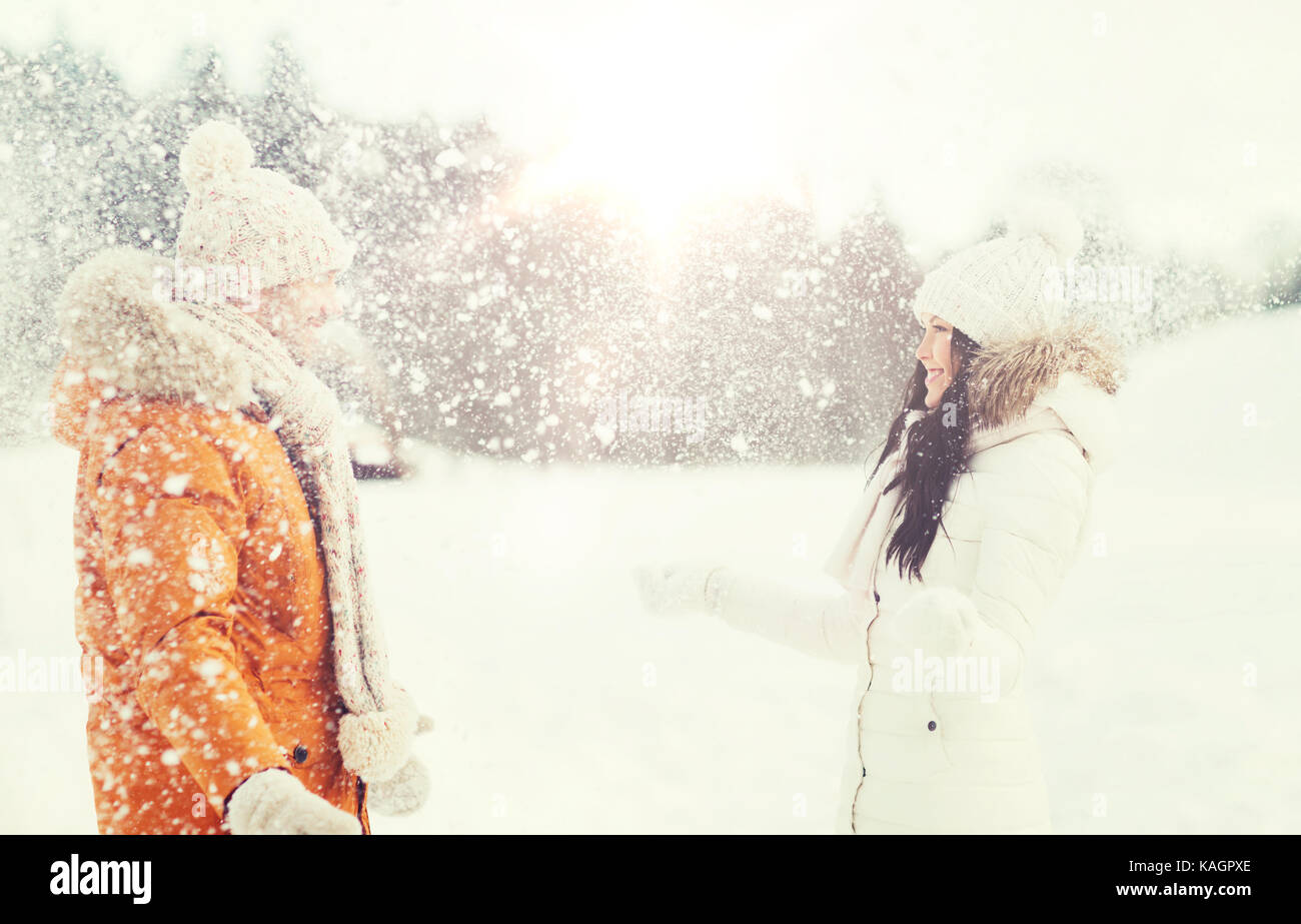 happy couple playing with snow in winter Stock Photo - Alamy