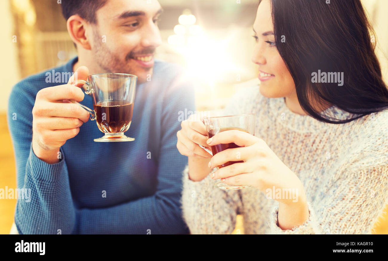 happy couple drinking tea at cafe Stock Photo - Alamy