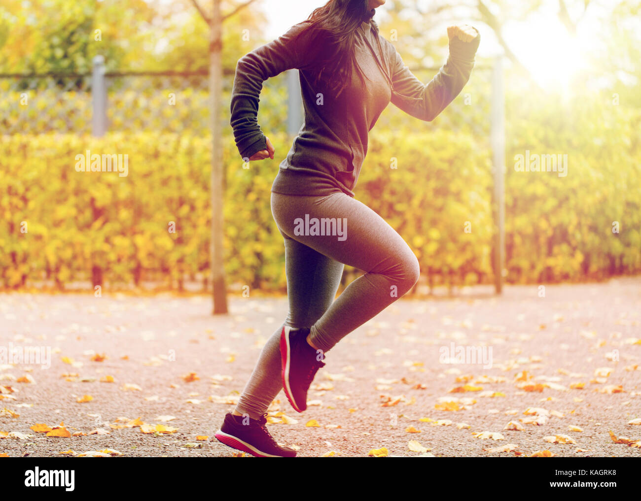 close up of young woman running in autumn park Stock Photo - Alamy