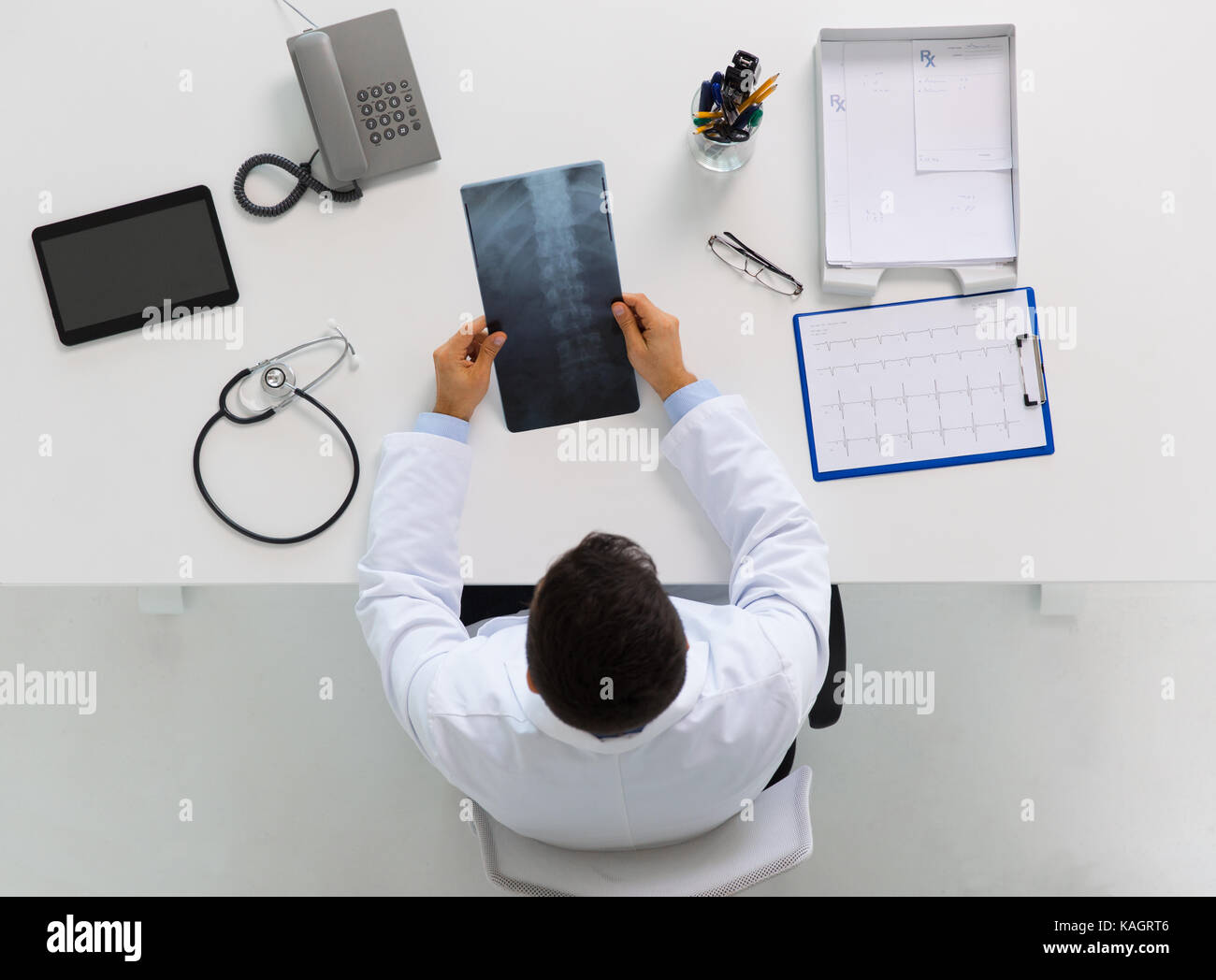 doctor with spine x-ray sitting at table Stock Photo - Alamy