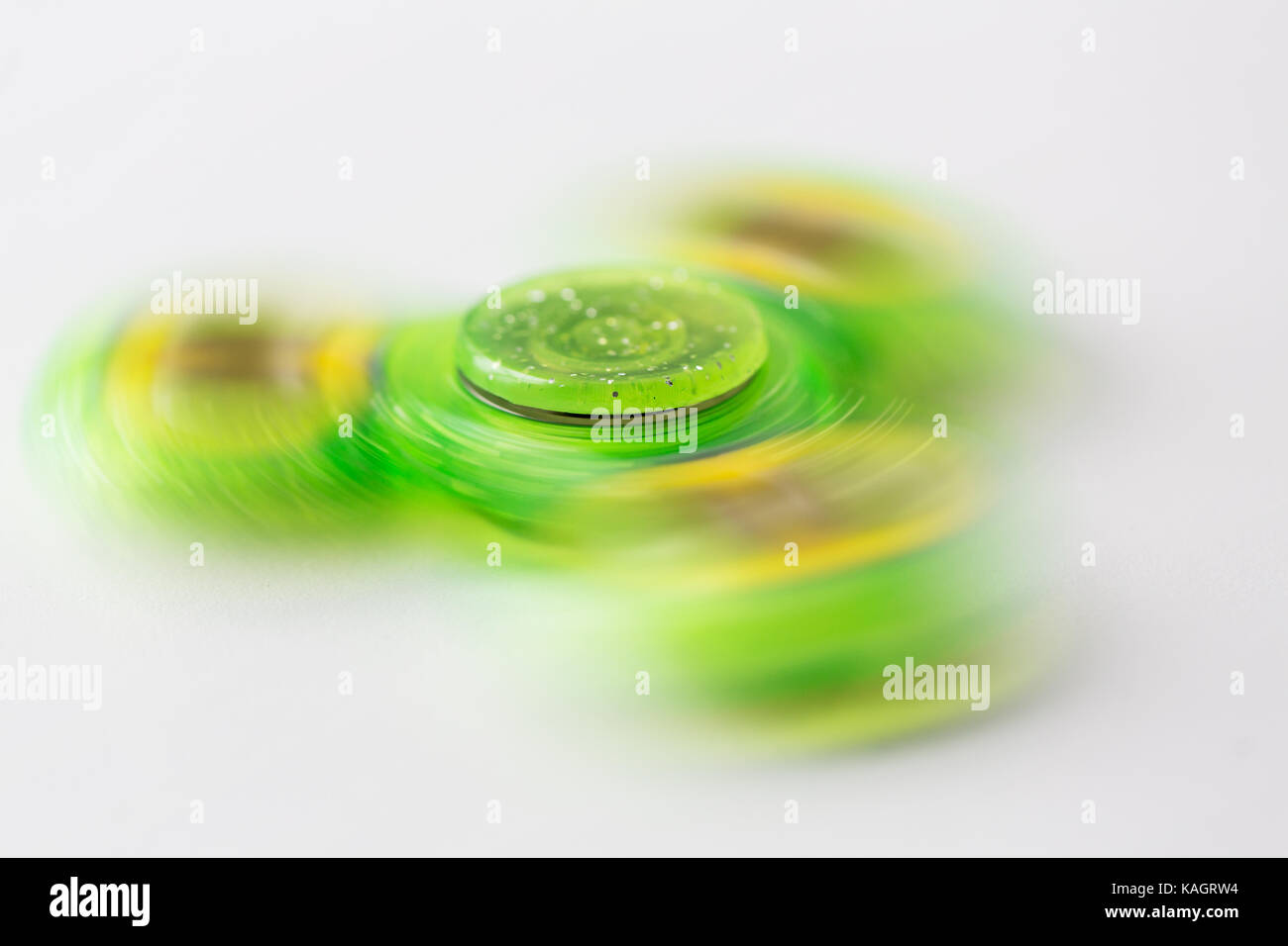 close up of lime green spinning fidget spinner Stock Photo - Alamy