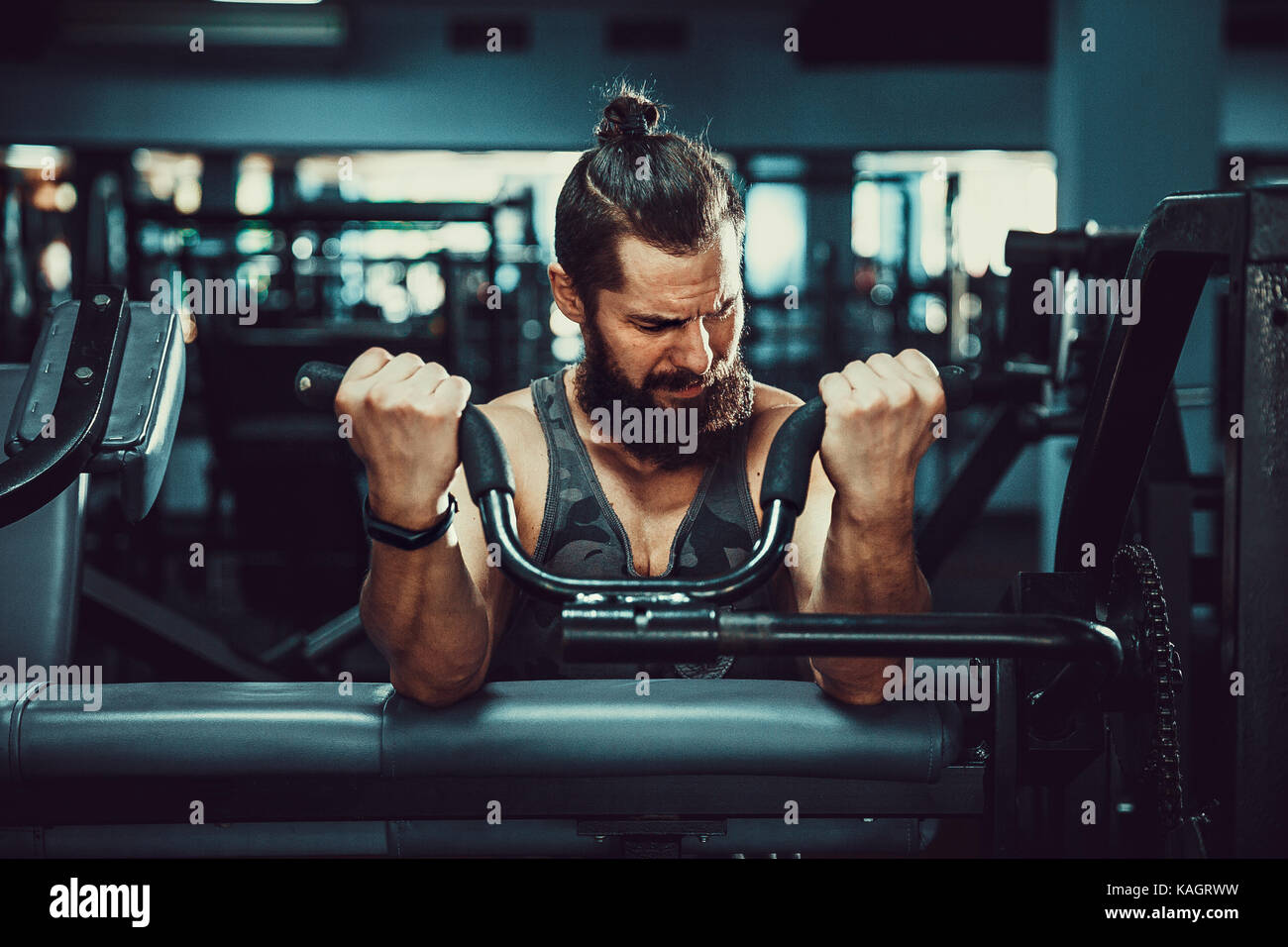 Man Doing Heavy Weight Exercise For Biceps On Machine In A Gym Stock ...