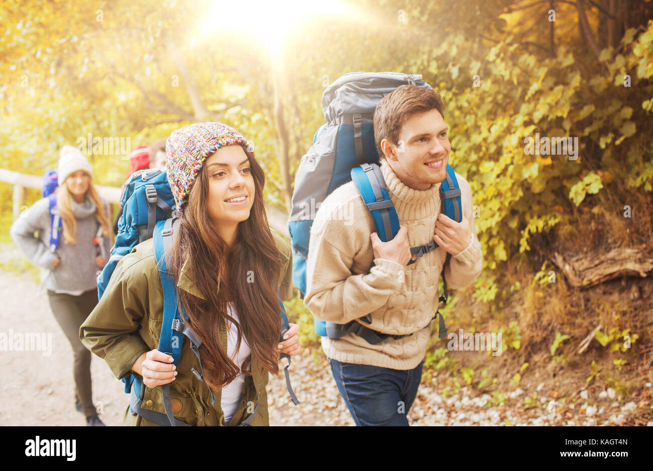 group of smiling friends with backpacks hiking Stock Photo - Alamy
