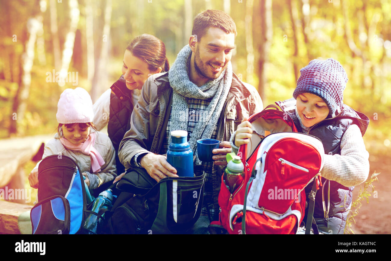 happy family with backpacks and thermos at camp Stock Photo - Alamy