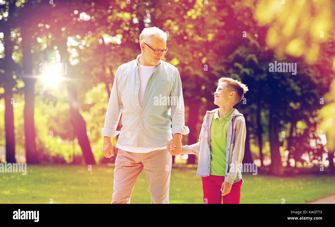 grandfather and grandson walking at summer park Stock Photo - Alamy