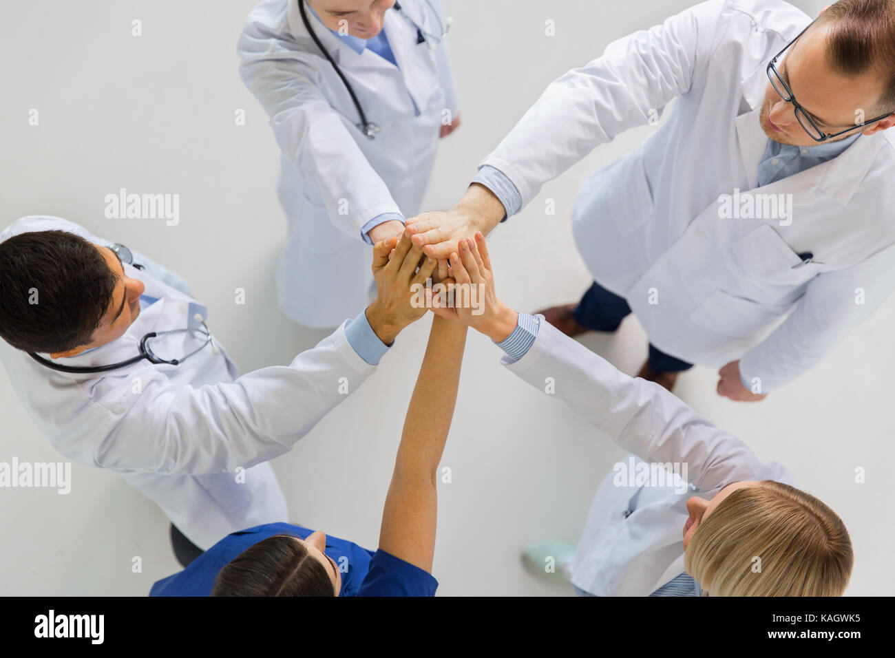 group of doctors making high five at hospital Stock Photo - Alamy